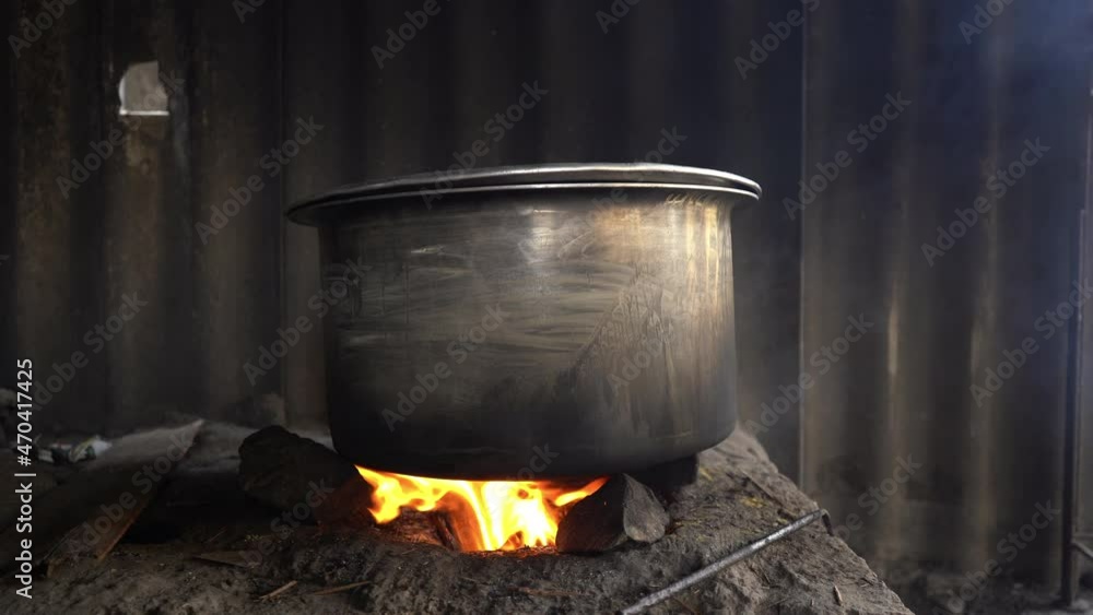 Wood burning stove, Cooking food in metal container on firewood, India ...
