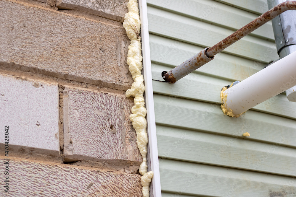 Wall cladding with siding. Foaming insulation with polyurethane foam ...