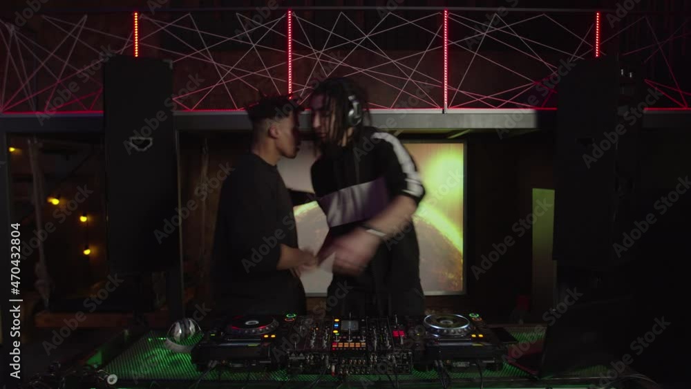Positive stylish black male clubber greeting, embracing and asking cool ...