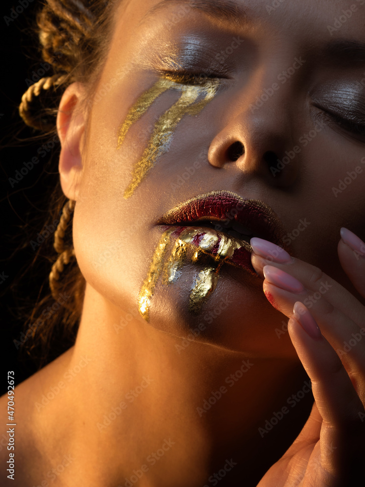 Gold on the skin, face art and creative makeup, gold as tears and blood ...