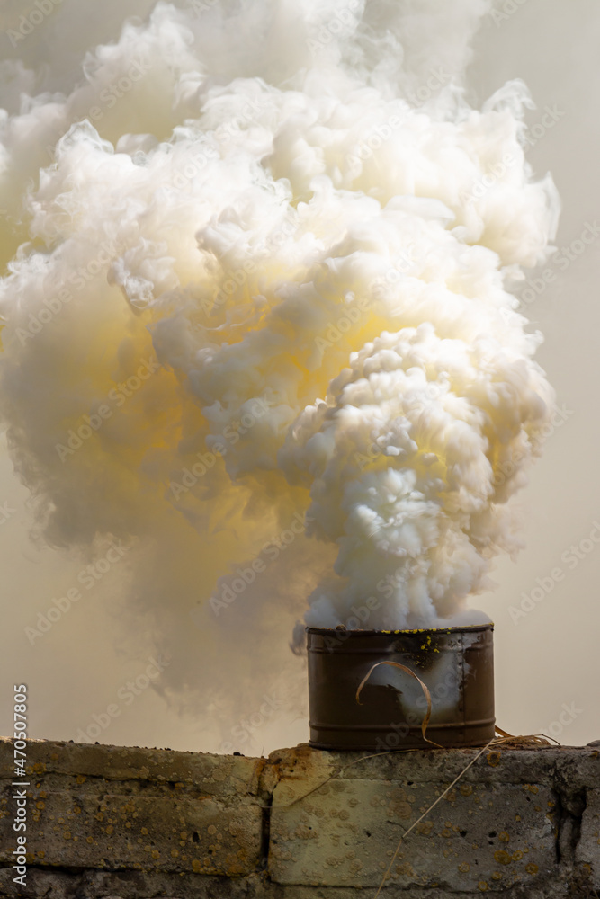 The fuming smoke grenade on a destroyed brick wall during tactical ...