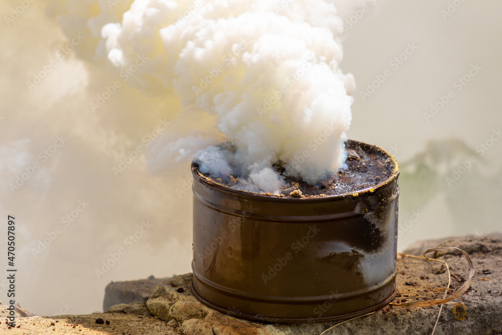 The fuming smoke grenade on a destroyed brick wall during tactical ...