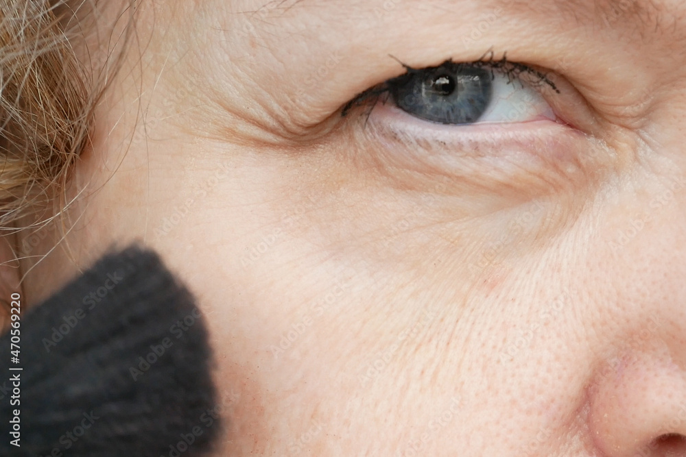 middle-aged woman does makeup, woman with drooping eyelid. Ptosis is a ...