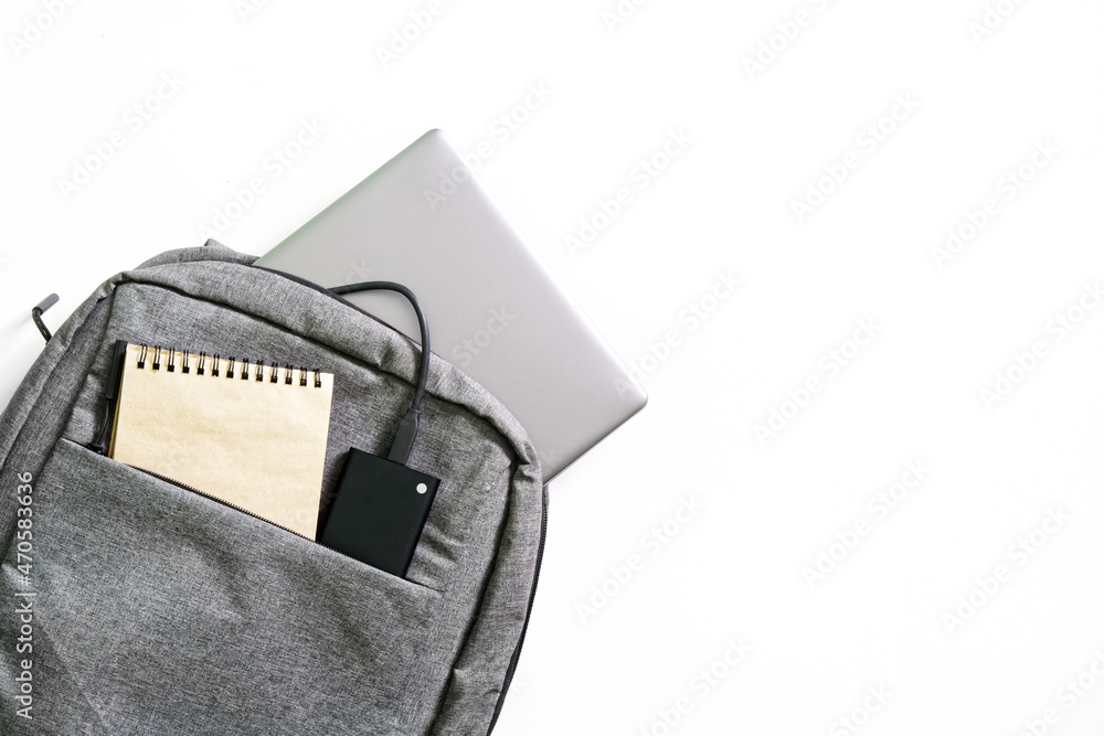 Gray urban backpack with laptop, notepad and external ssd on a white ...