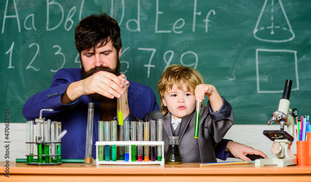 More Intelligence Solutions. man with little boy. Chemistry beaker ...