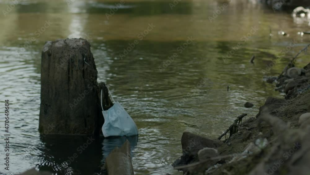 Medical Face Mask Floating in the Water. Waste during COVID-19 ...