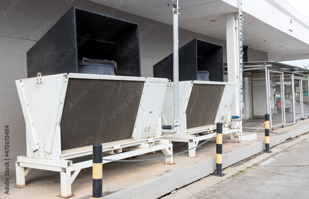 Air conditioner compressor installed in old building. Cooling towers in ...