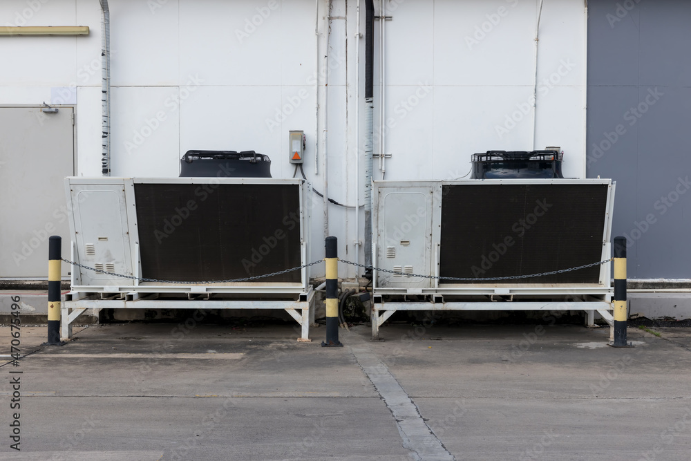 Air conditioner compressor installed in old building. Cooling towers in ...