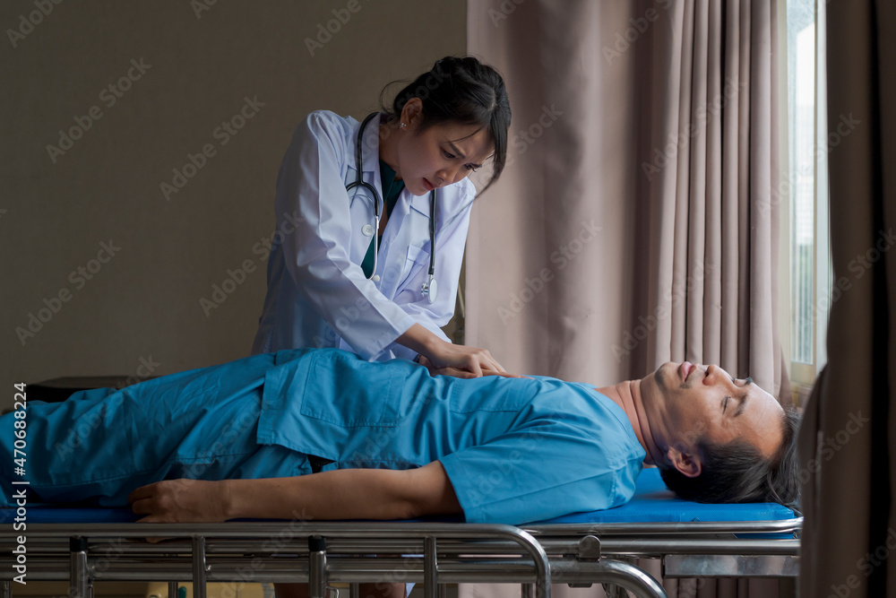 Doctor doing cardio pulmonary resuscitation on an unconscious patient ...