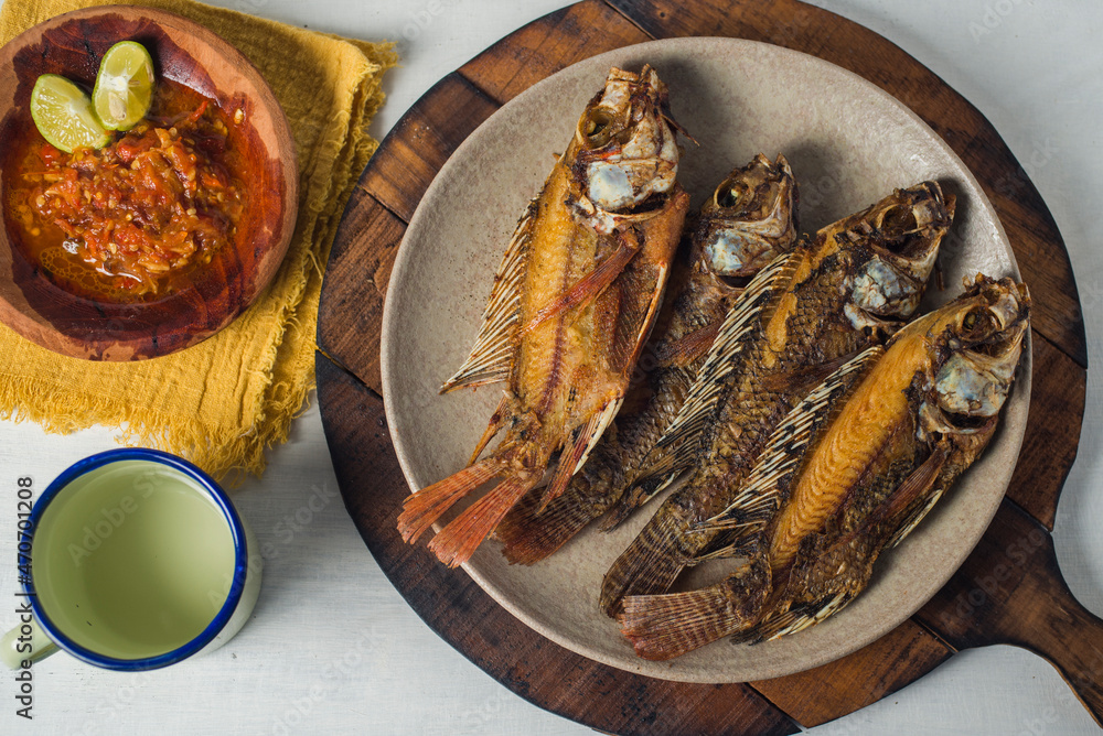 Fried Tilapia fish with cantella asiatica and hot and spicy sauce as ...