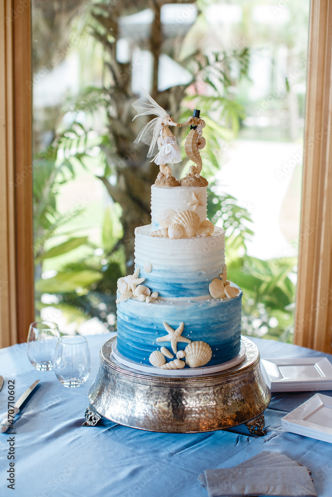 Seahorse wedding cake topper A three-tier buttercream wedding cake with ...