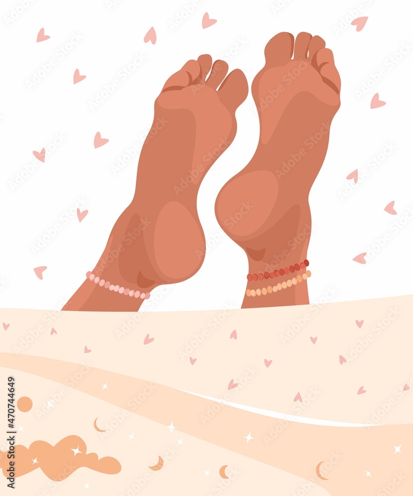Female feet sticking out from under the blanket. Morning in bed ...