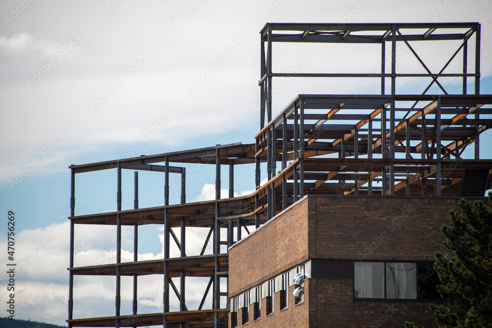 The exterior construction of a large multi-story high-rise building is ...