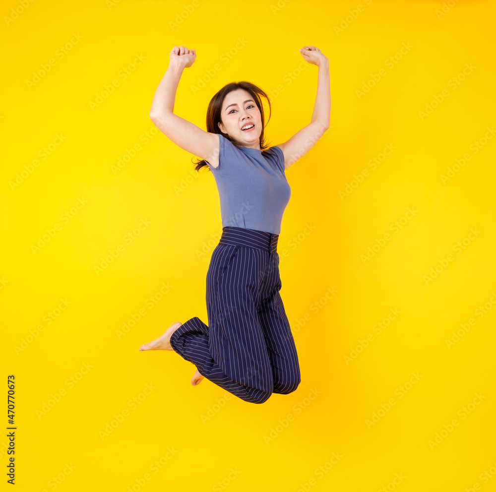 Beautiful Asian woman jumping freely in air for freedom fly as happy on ...