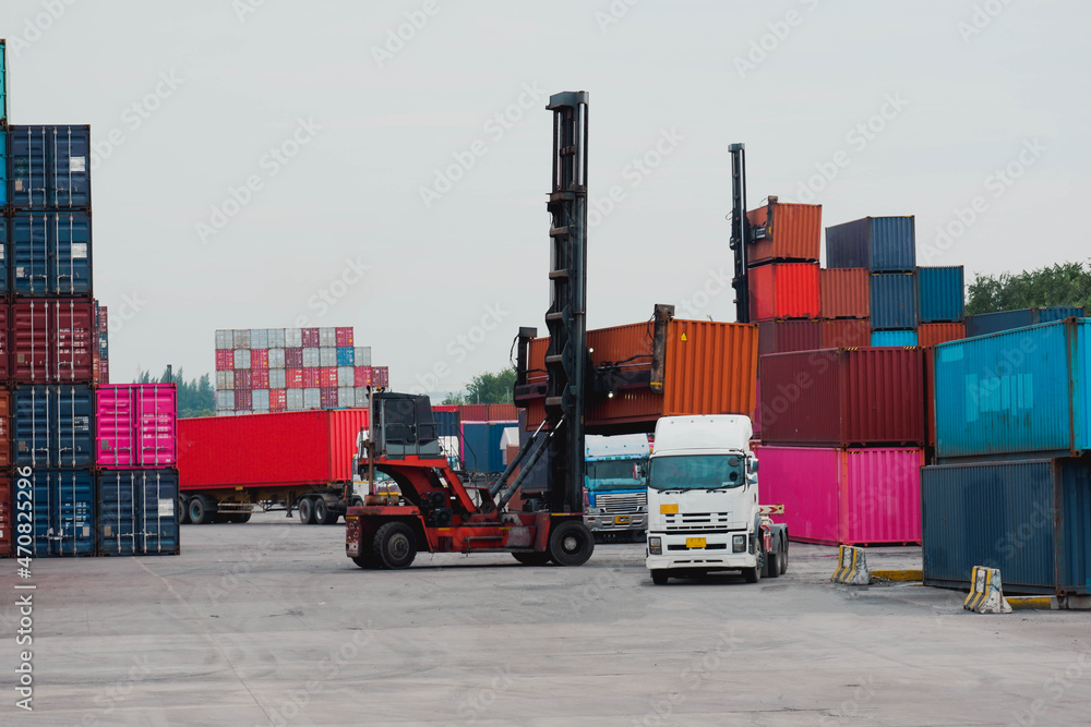 Forklift truck lifting cargo container in shipping yard or dock yard ...