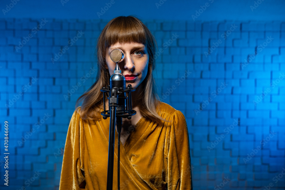 Young cheerful caucasian singer girl with blond hair and bangs in ...