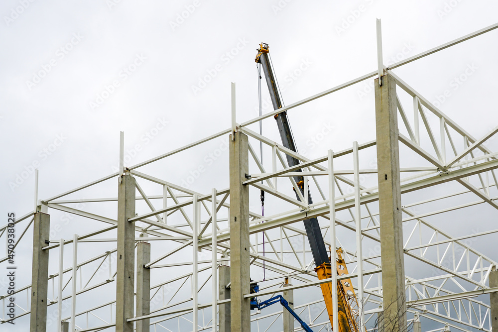 crane with telescopic boom in the assembly of metal structures of an ...