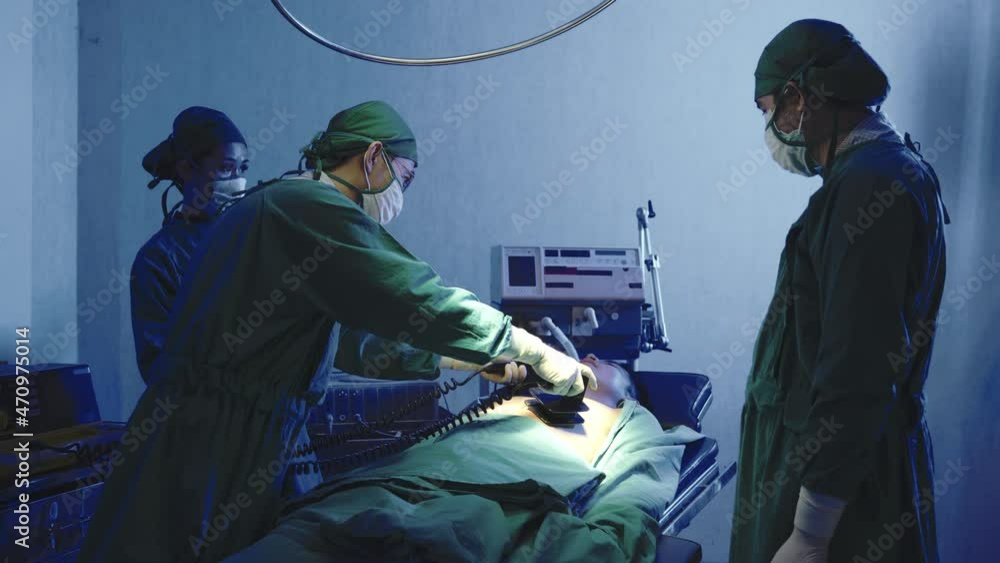 Defibrillation cardiac dysrhythmia, Surgical doctor team performing ...