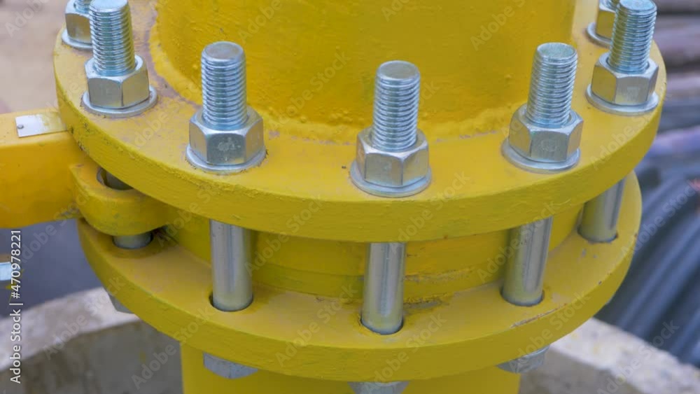 Bolt with screw nut connect two part of yellow pipes at heavy industry ...