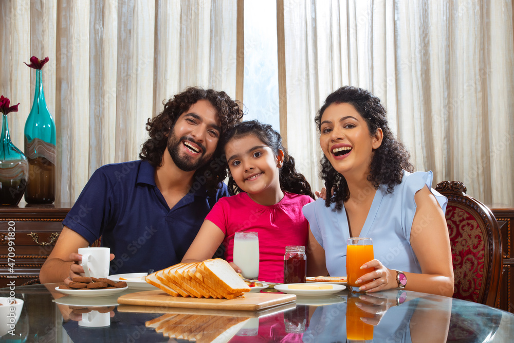 Family members posing in front of camera while sitting together at ...