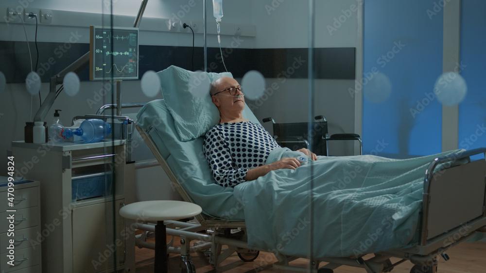 Old patient with breathing problems sitting in hospital ward for ...