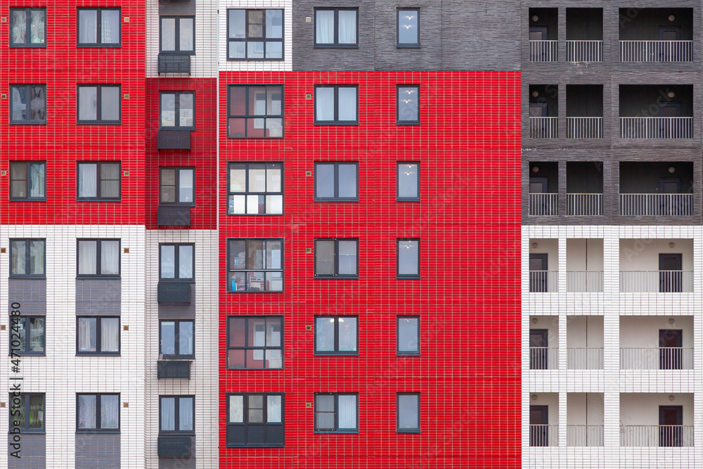 Background image - a multi-colored wall of a multi-storey building with ...