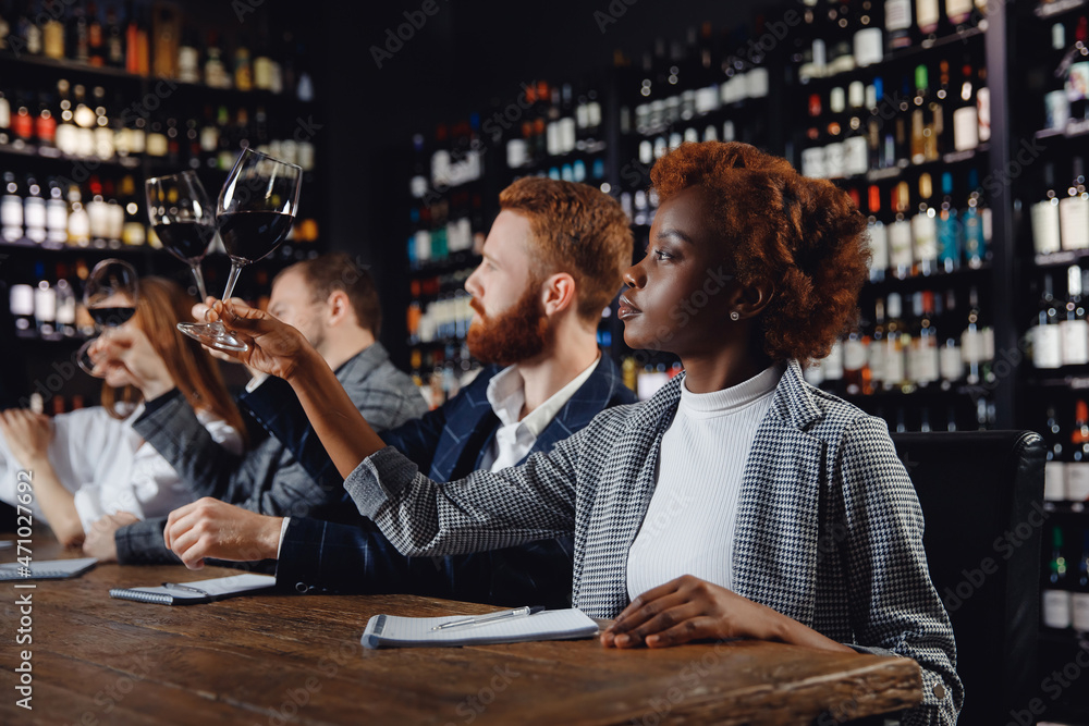 Tasting red wine Professional sommeliers man and woman and taking notes ...