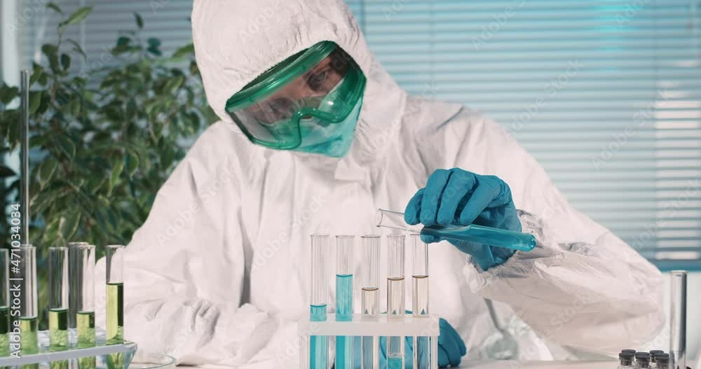 mix solutions in test tubes. a medic. test tubes with liquid, reagents ...