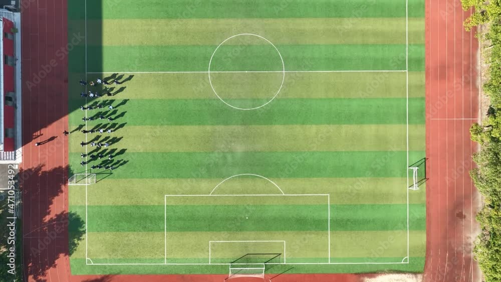 Drone aerial view of people running at the football stadium Shanghai ...