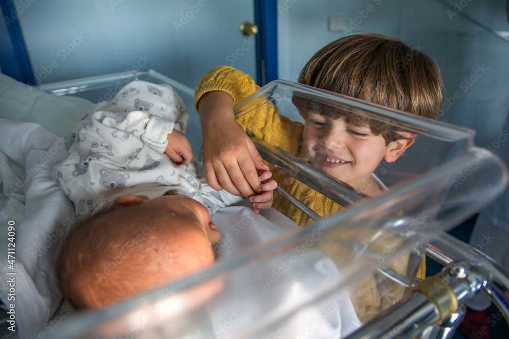 Child Visiting His Newborn Brother In The Maternity Ward On The Day Of ...