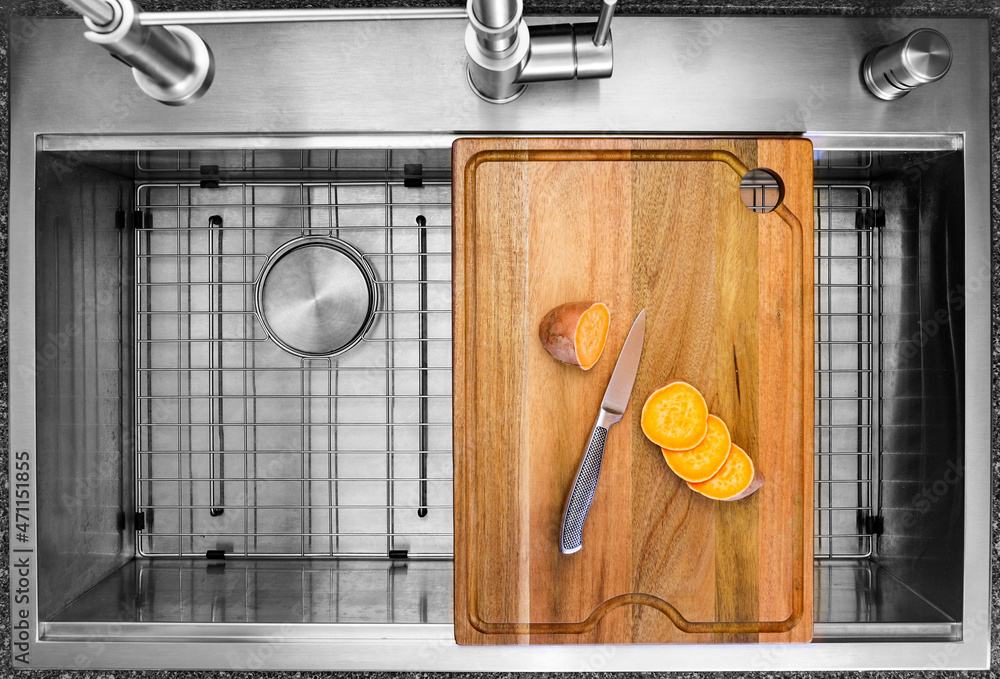 Workstation kitchen sink with cutting board used to slice a sweet ...