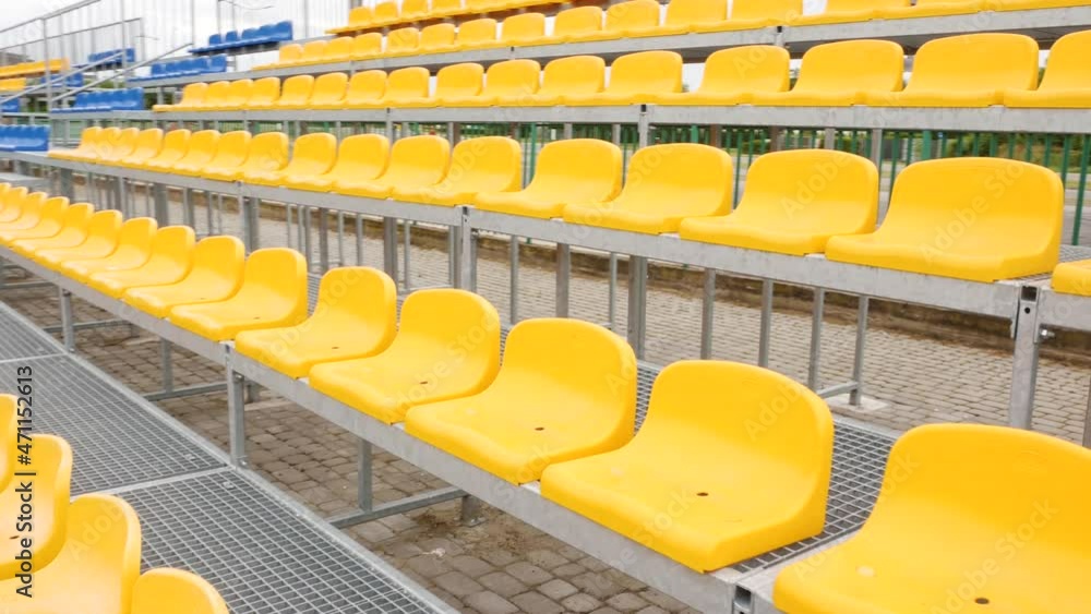 Empty vacant stadium stands, chairs, plastic yellow arena spectator ...