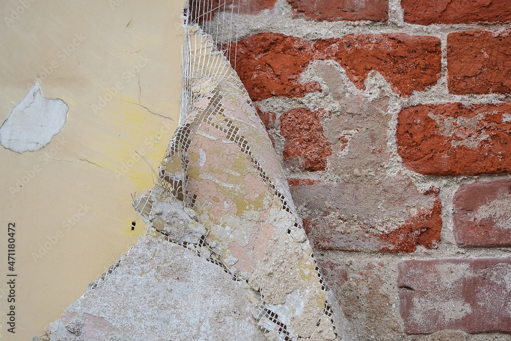 Exterior wall of a building with damaged stucco. Demonstration of poor ...