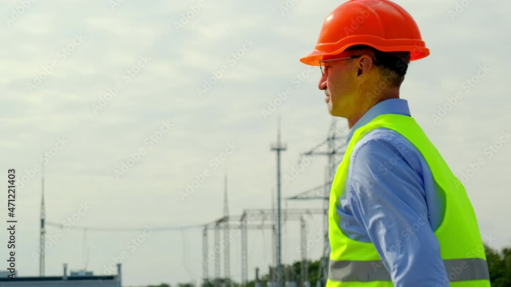 High voltage electrical transmission lines distribute power under ...