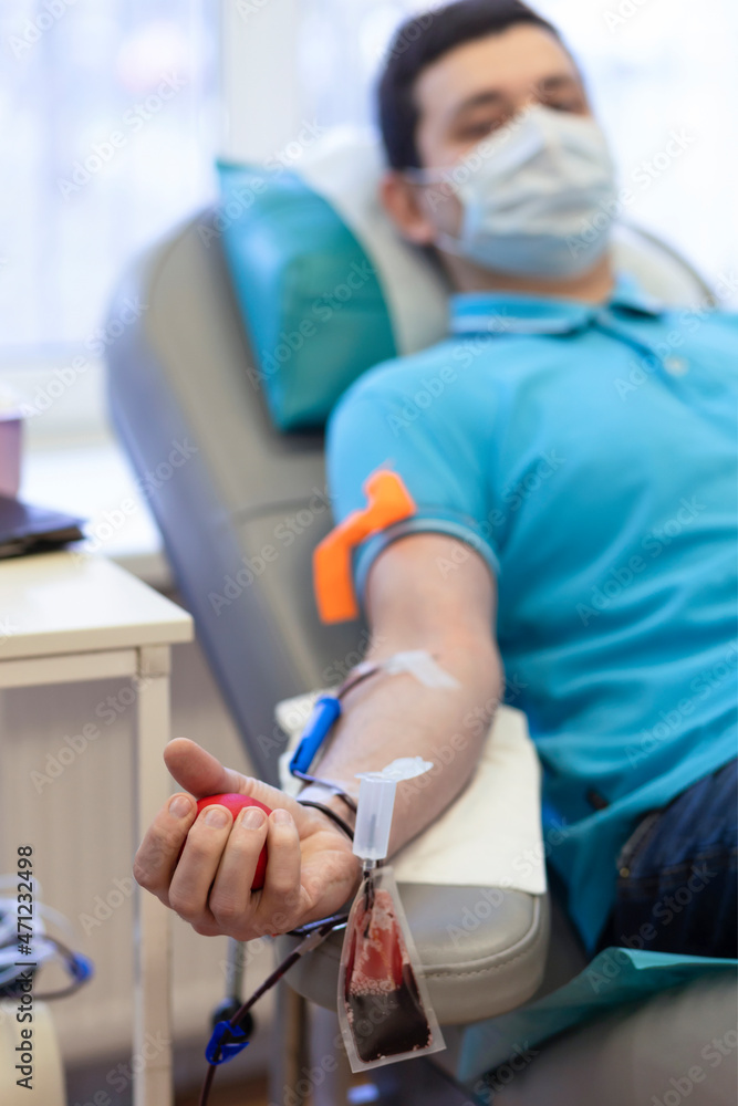 bone marrow donation. male hand holding red ball, blood transfusion ...