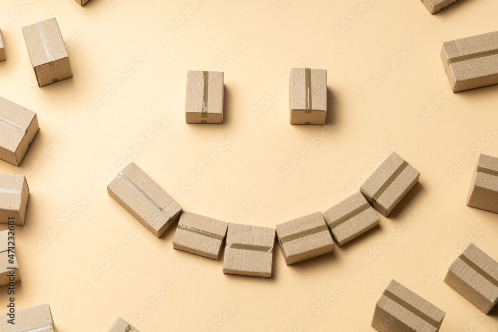 Smiling face from cardboard boxes on a light brown background Stock ...
