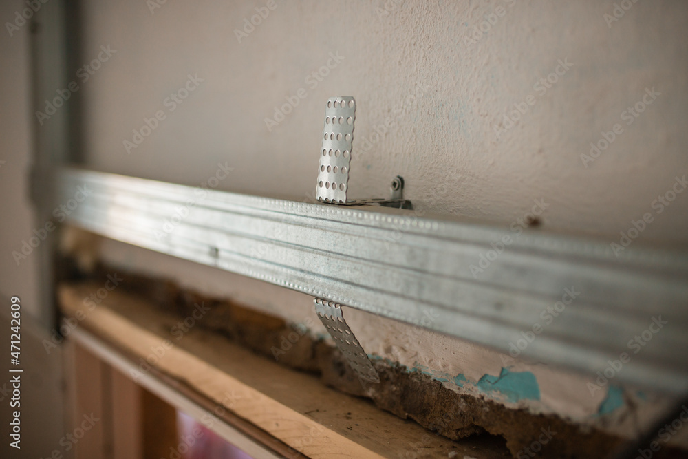 The worker installed a metal profile of the wall. Metal profiles. Metal ...