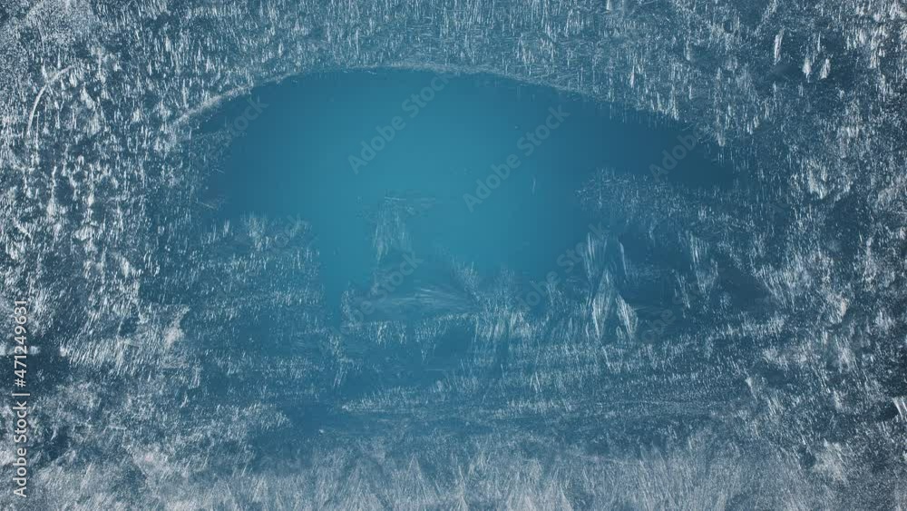 Frozen window with frosty patterns gradually fills with frost over its ...