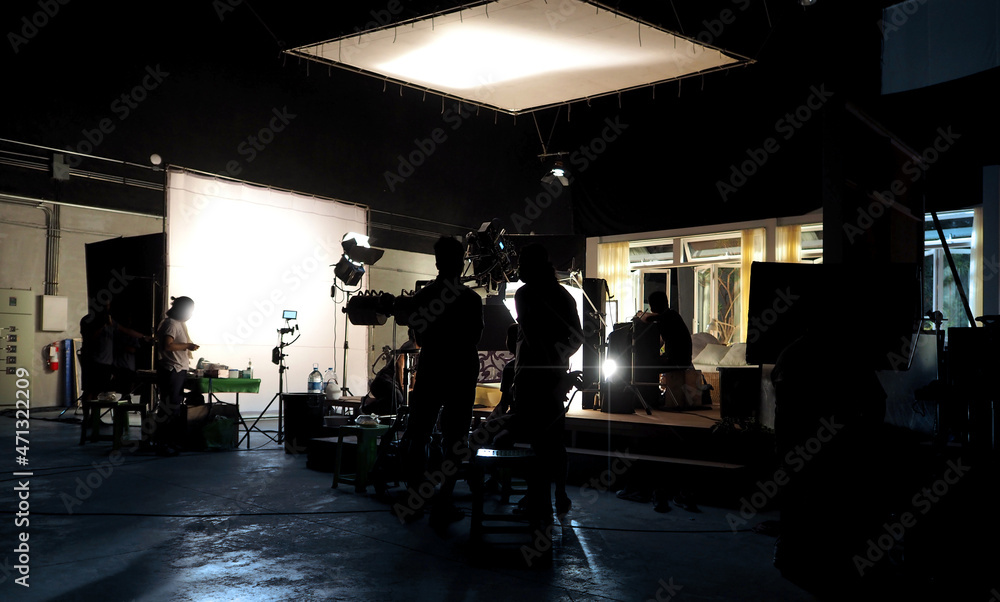 Video recording. Behind the scenes of silhouette people working in big ...