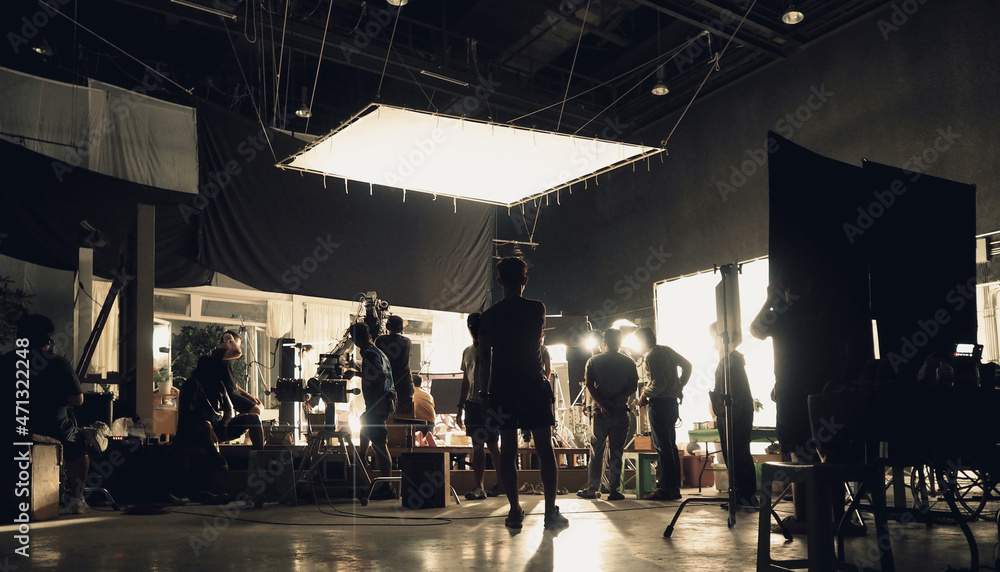 Video recording. Behind the scenes of silhouette people working in big ...