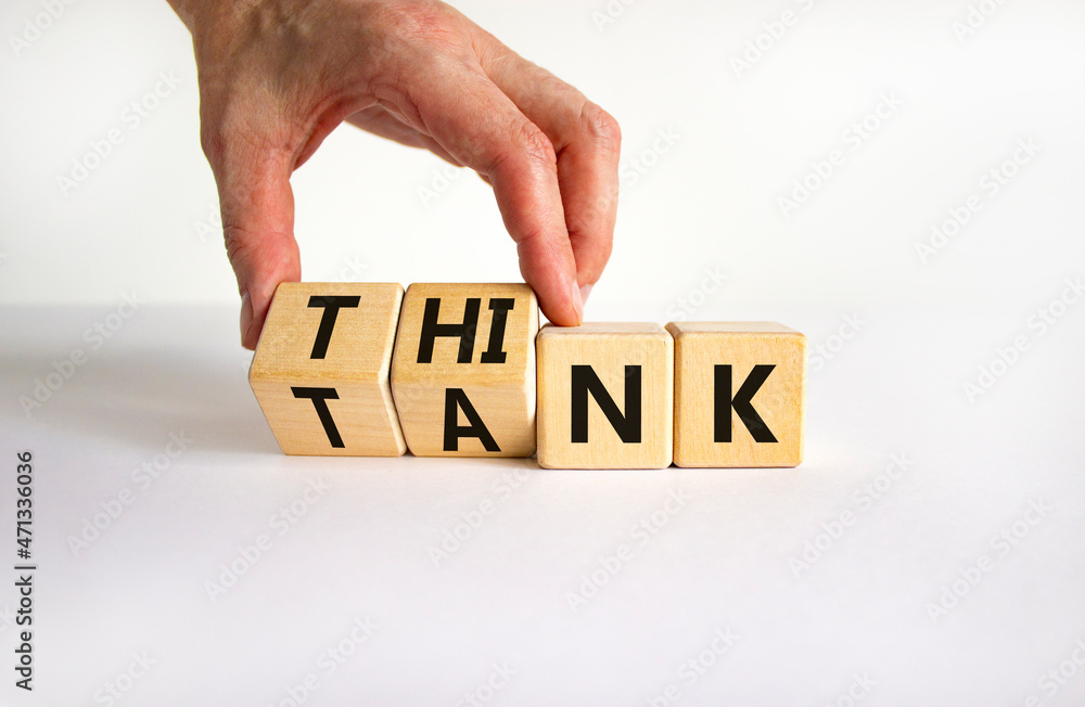 Think tank symbol. Businessman turns wooden cubes and changes the word ...