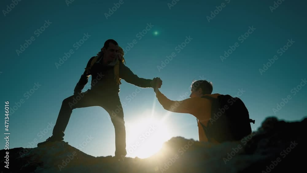help team concept. team silhouette of two climber stretching a helping ...