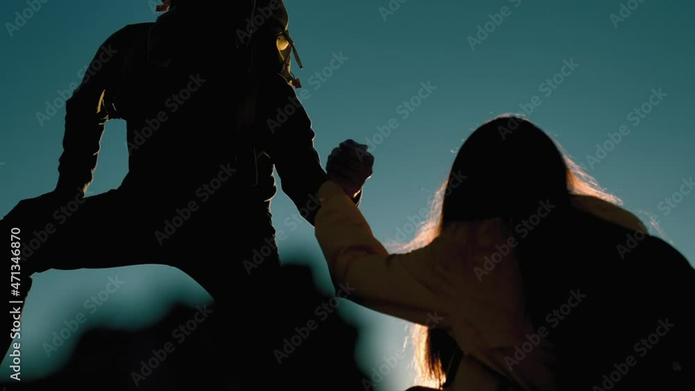 help team concept. couple team silhouette of two climber stretching a ...