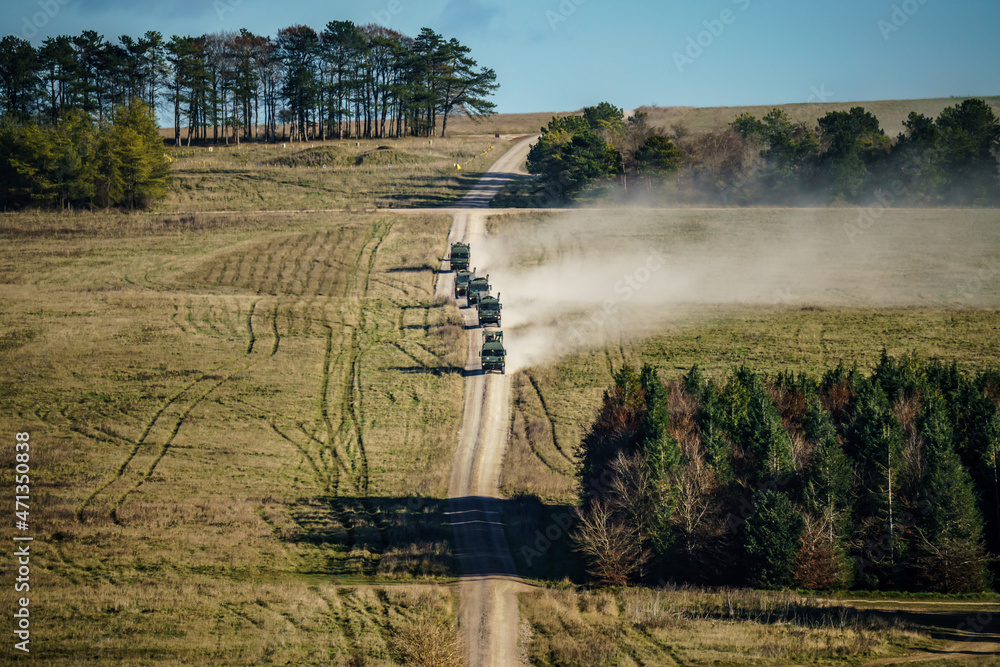 Convoy of British army MAN SV 8x8 EPLS army logistics trucks kicking up ...