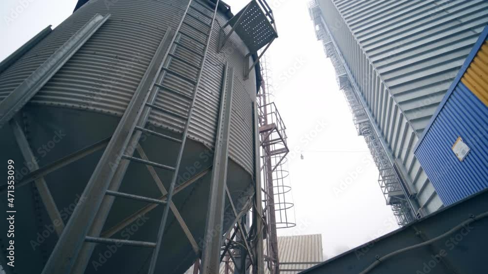 Huge silo tank with the metal ladder and a little balcony. A turning ...