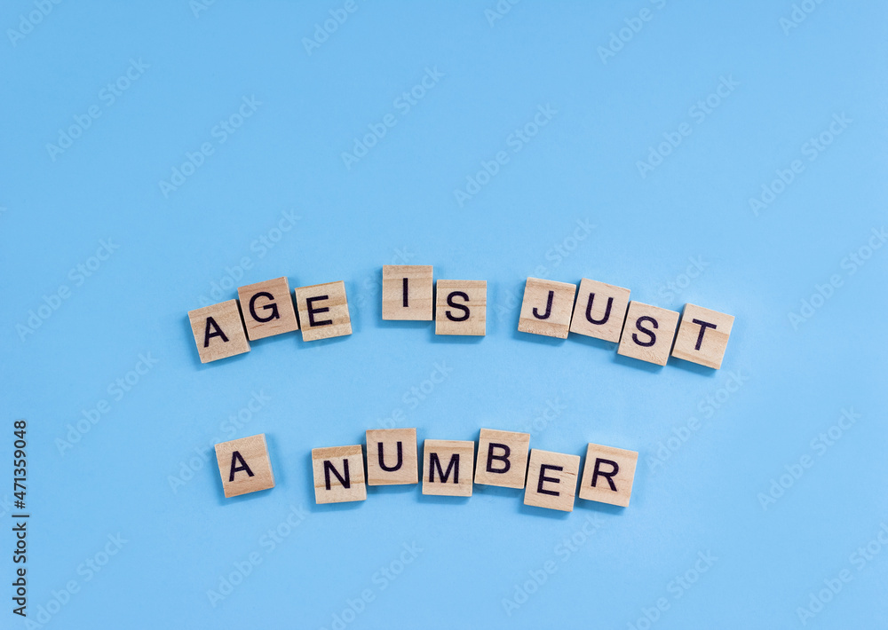 Phrase Age is just a number. Wooden blocks with lettering on a blue ...
