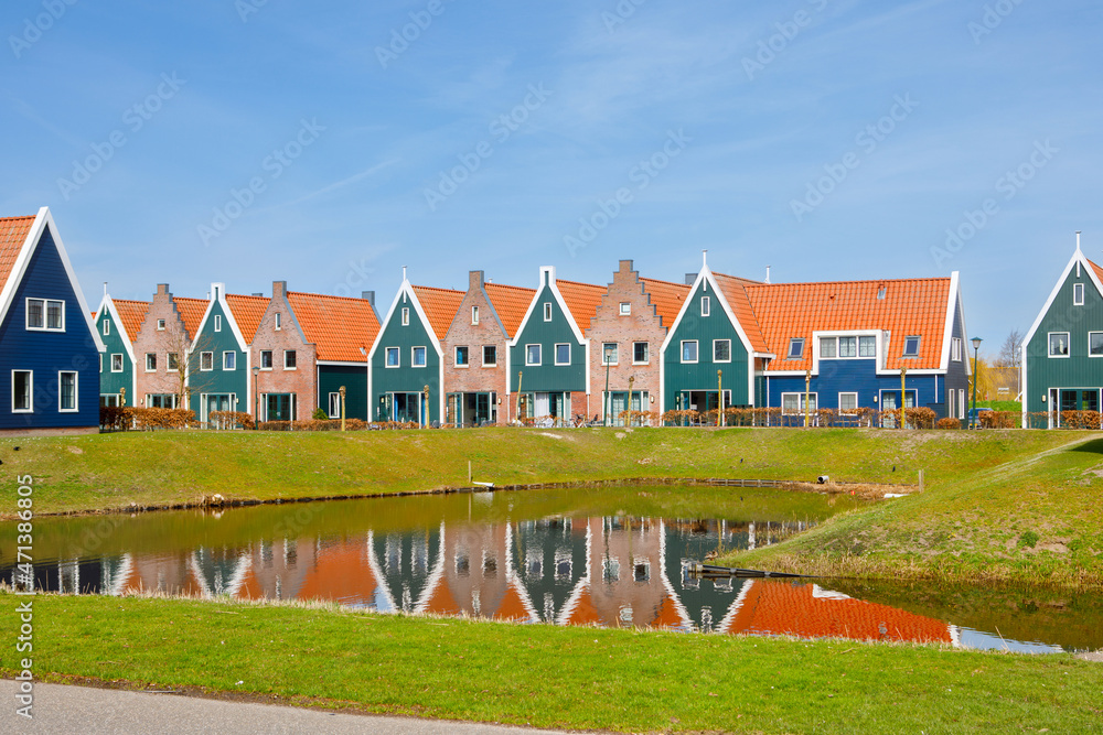 Panorama with modern brick houses along water in a family friendly ...