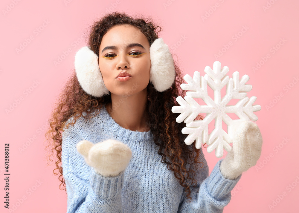 Beautiful African-American woman with big snowflake blowing kiss on ...