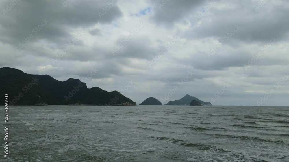 Low altitude reverse aerial footage revealing the rushing waves ...