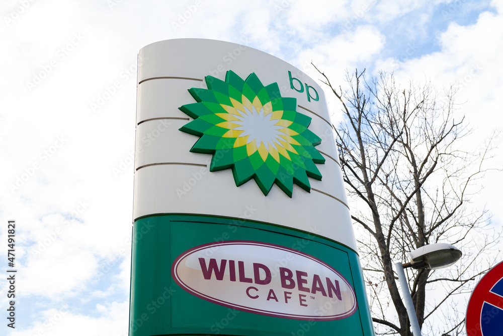 BP and Wild Bean Cafe sign outside a petrol station. British Petroleum ...